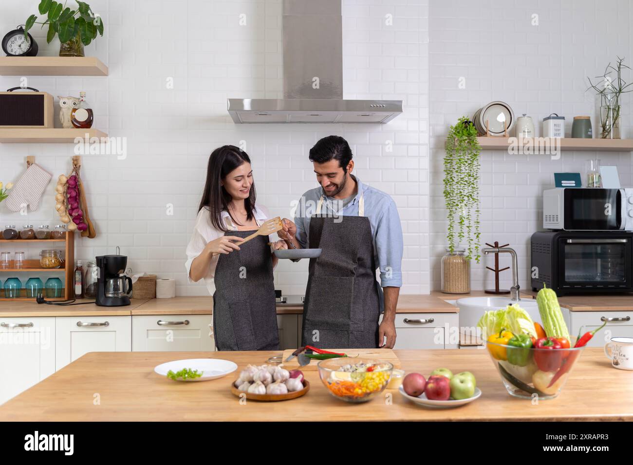Romantic couple is cooking in the kitchen. A handsome man and a ...