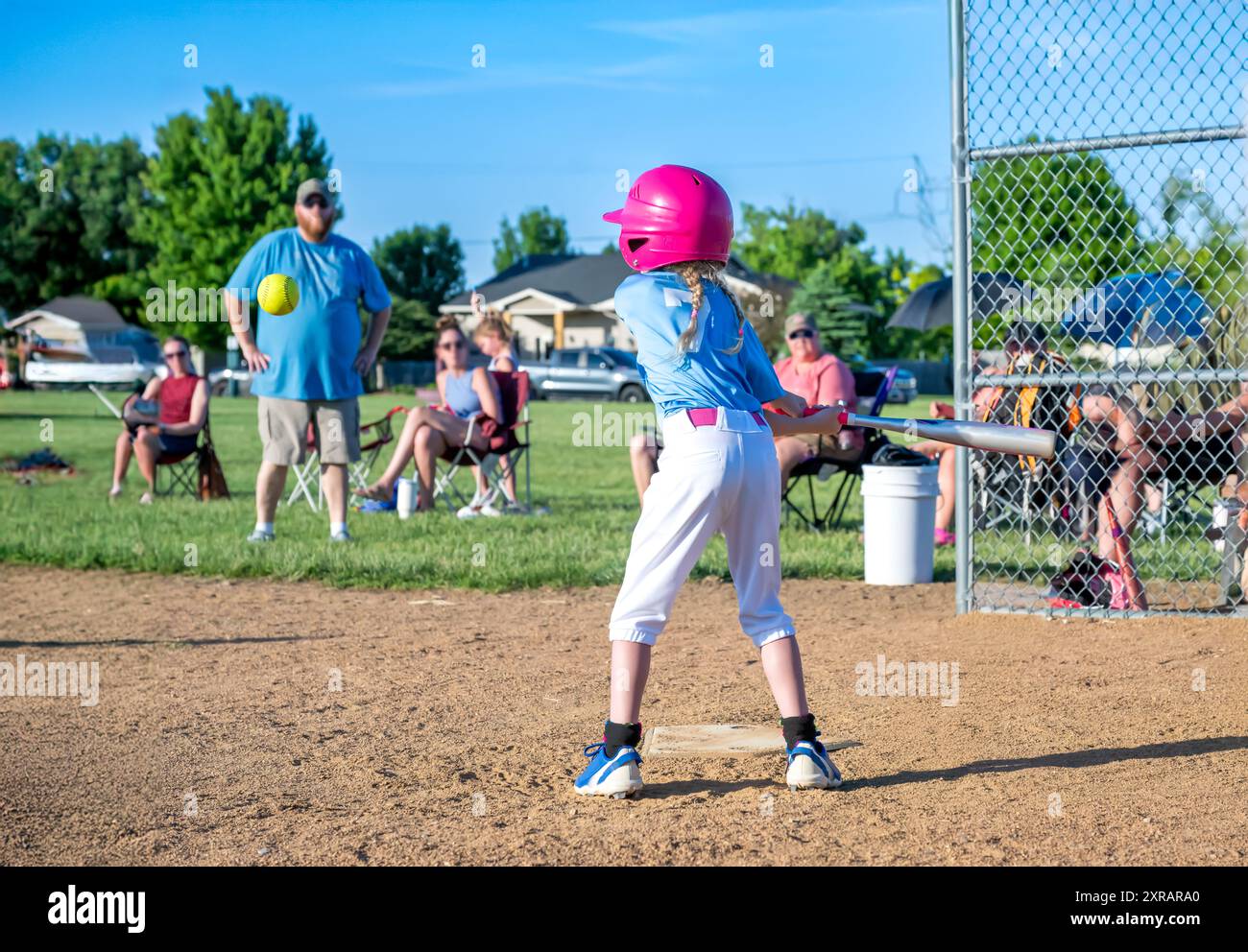 Youth girl softball player at bat during a game Stock Photo - Alamy
