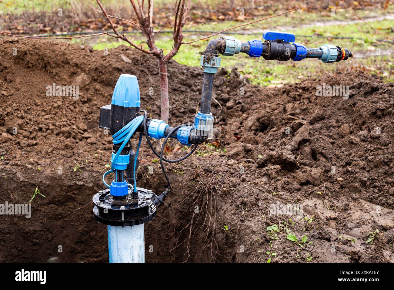 water intake unit in a well dug in the ground. Installation of a water ...
