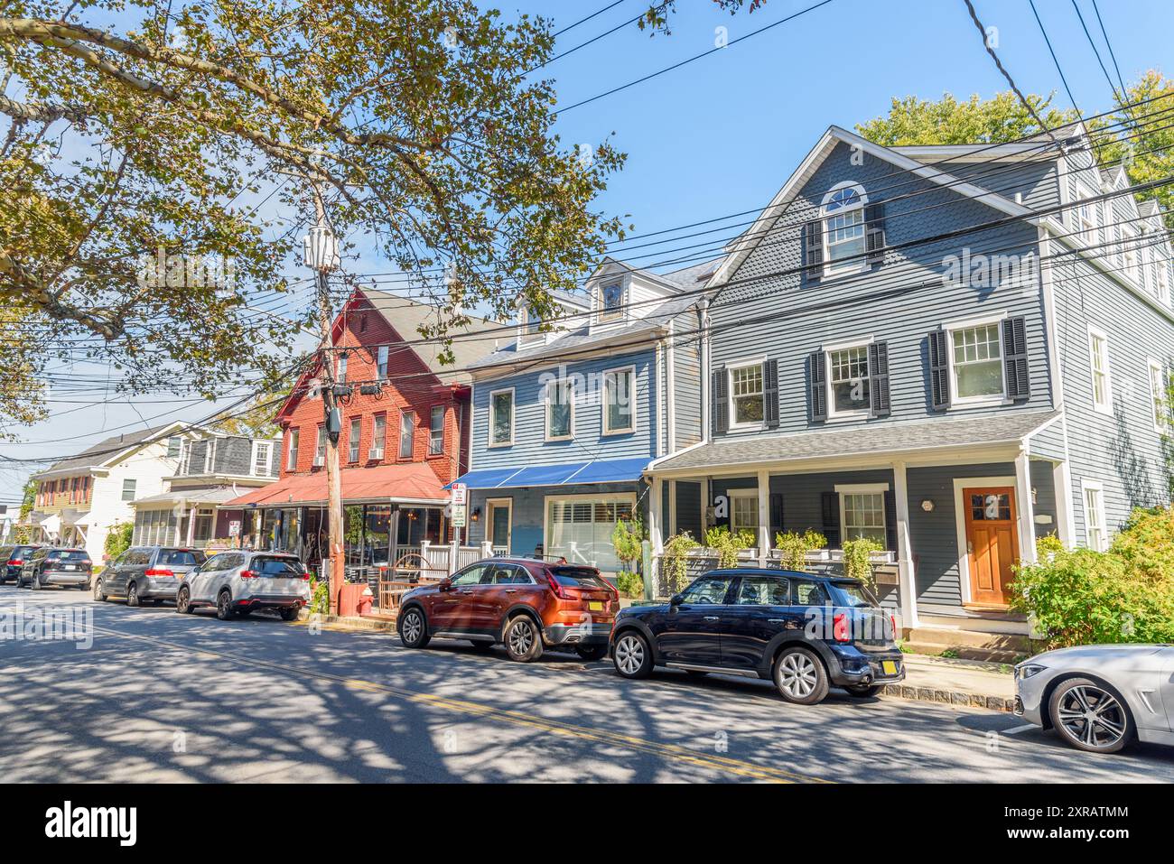 Row of colourful wooden residential and commercial buildings along a ...