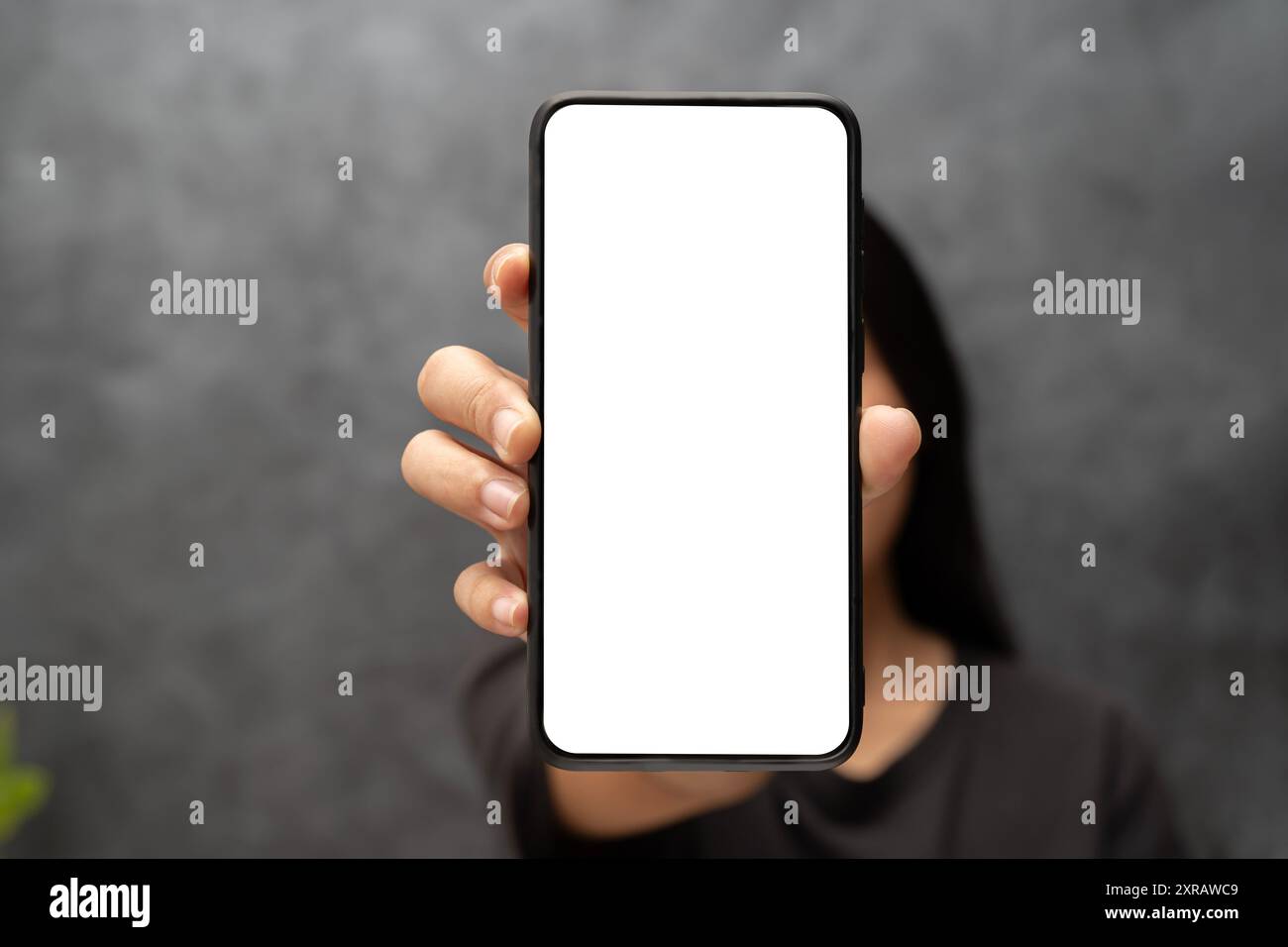 Mock up of beautiful woman pointing finger at mobile phone with blank ...