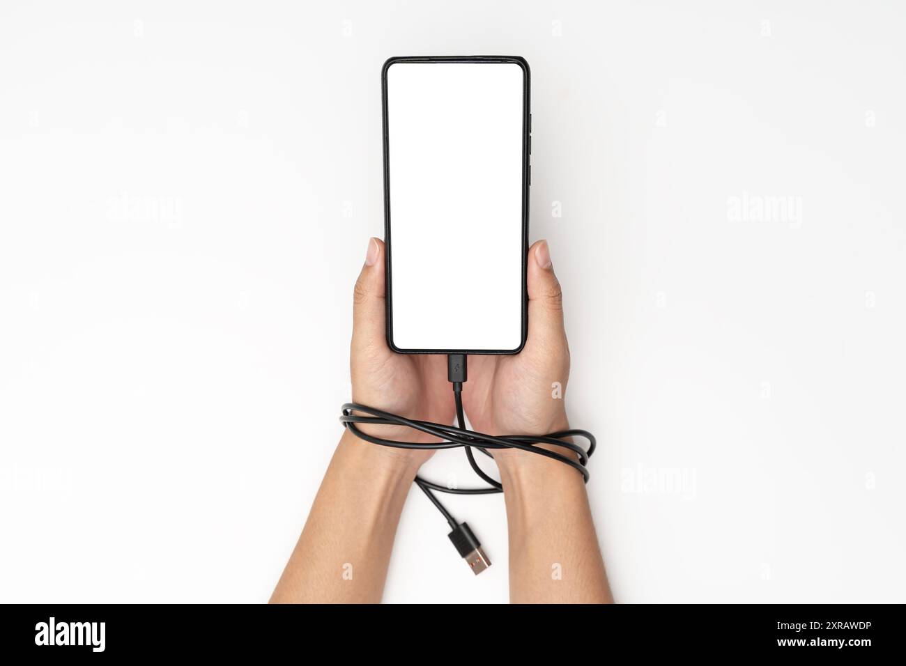 Woman hands trapped and wrapped on wrists with mobile phone cable as ...