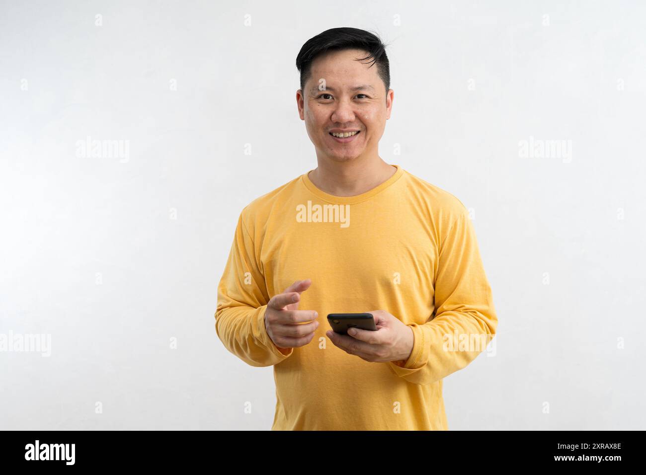 Attractive man with short black hair chatting or typing message using ...