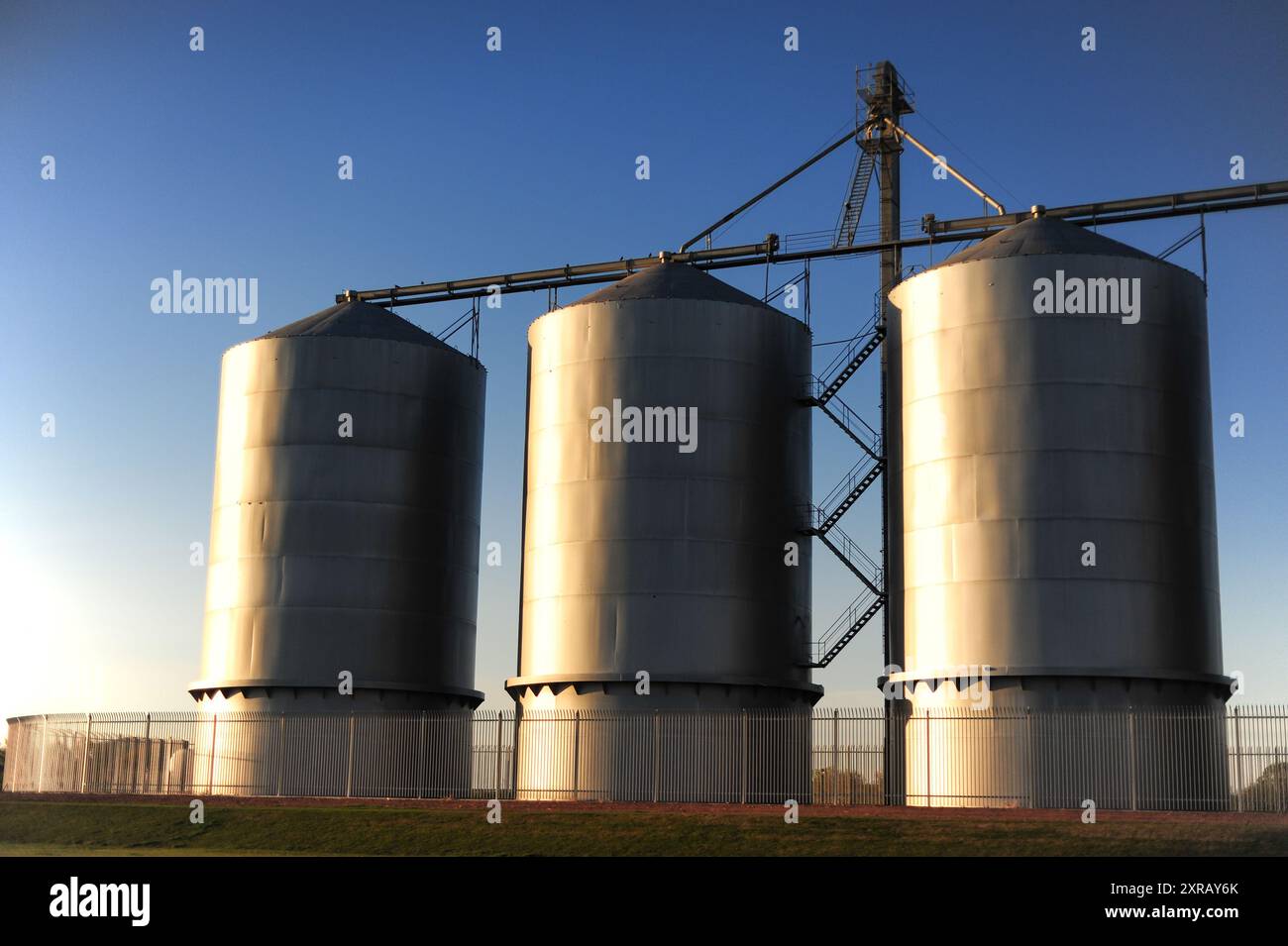 A crew of construction workers atop wooden structures, building a multi ...