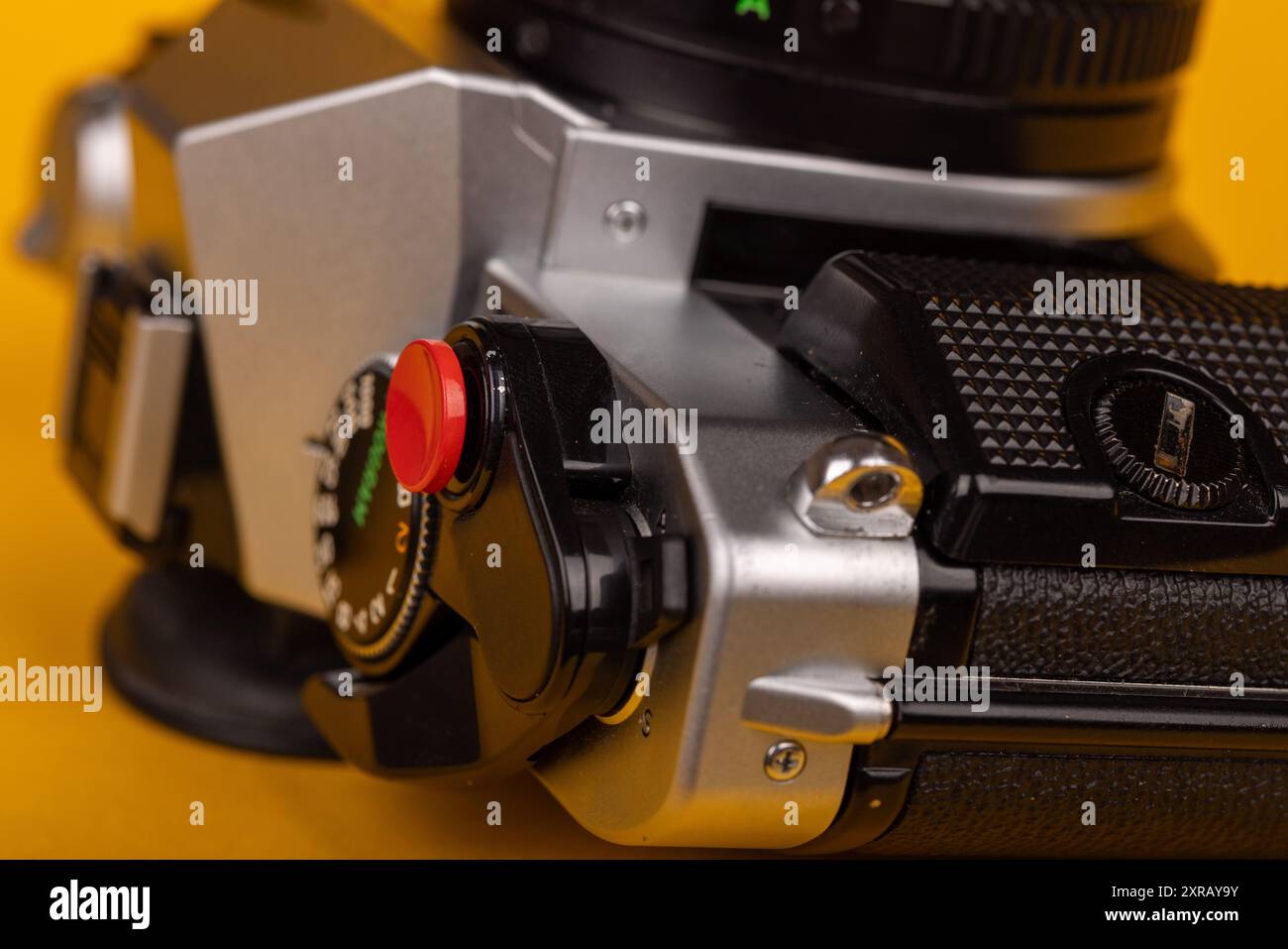 A close-up shot of an old camera lying on its back with the lens facing ...