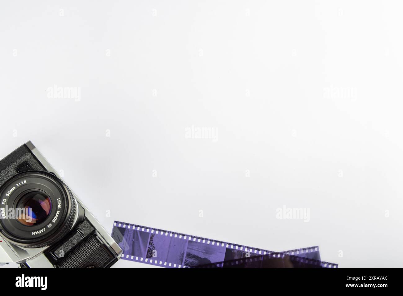 Antique camera with 35mm film rolls and developed film viewed from ...