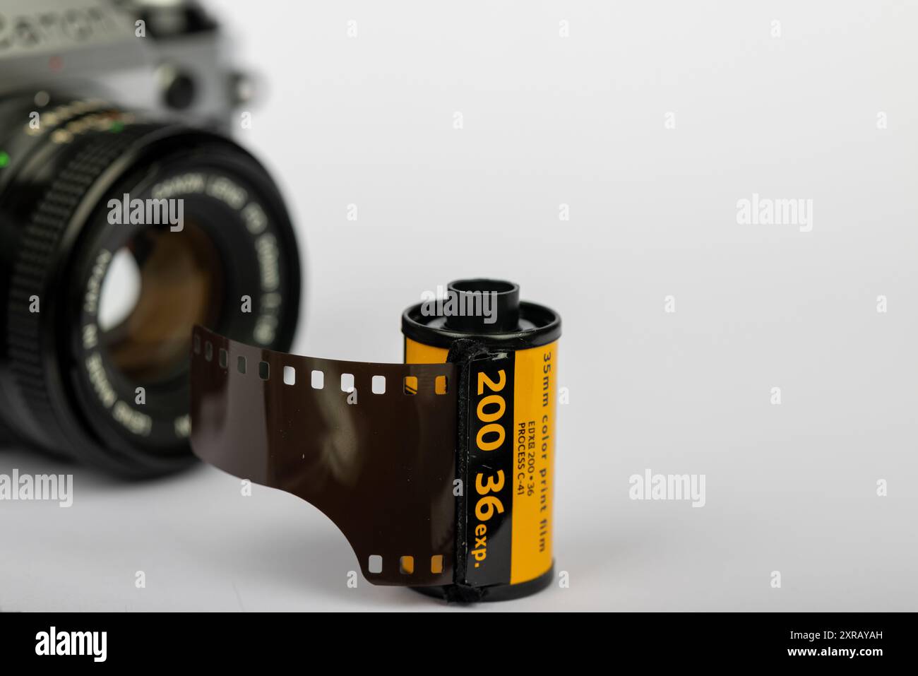 A roll of 35mm film in sharp focus with an old-fashioned camera ...