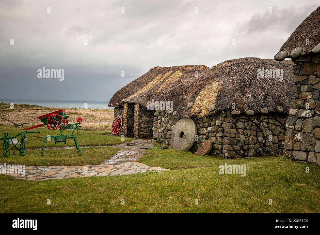Traditional stone cottages with thatched roofs and vintage farming ...