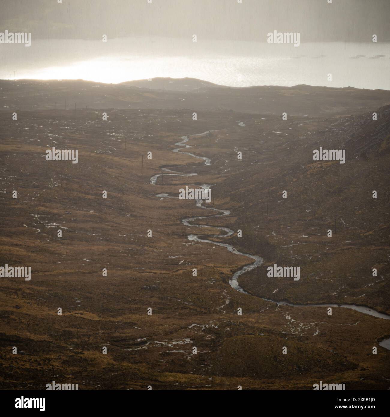 Aerial view of a winding river flowing through a barren landscape with ...