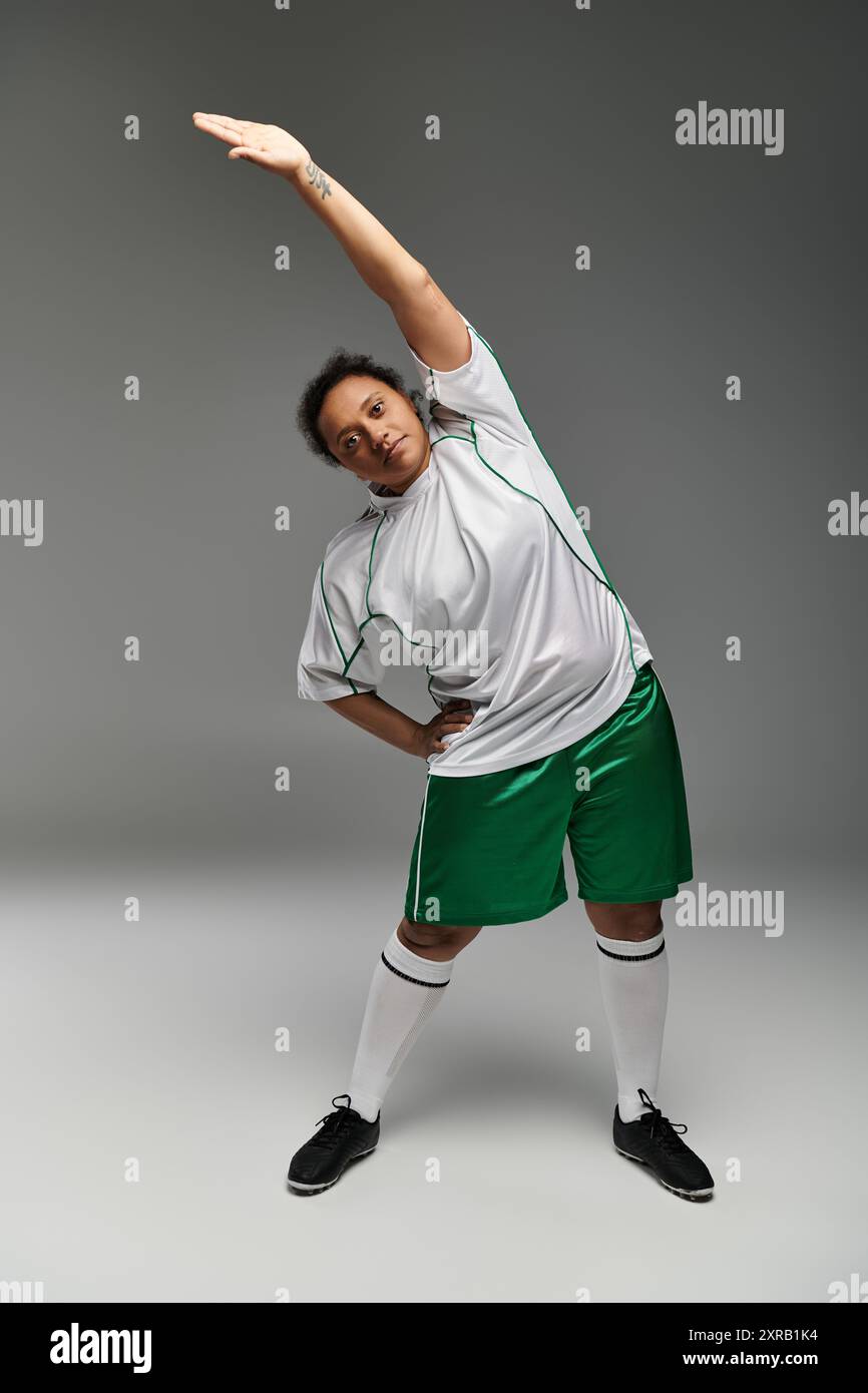 A female athlete stretches her arm before a football match Stock Photo ...