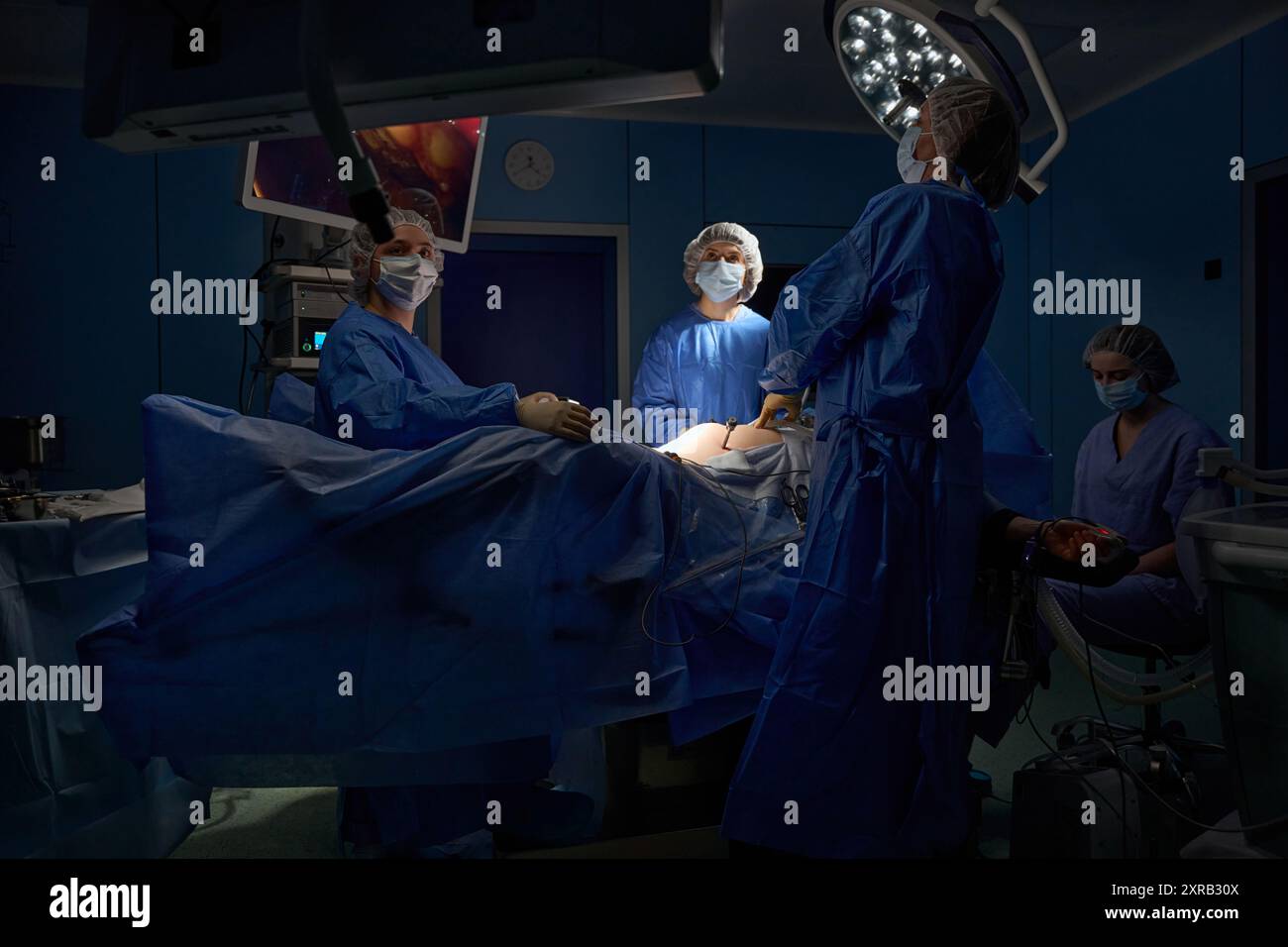 Surgeons in sterile surgical gown in the operating room doing operation ...