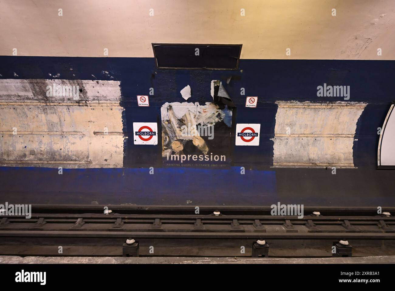 An old ripped poster advertising French Impressionism on a disused ...