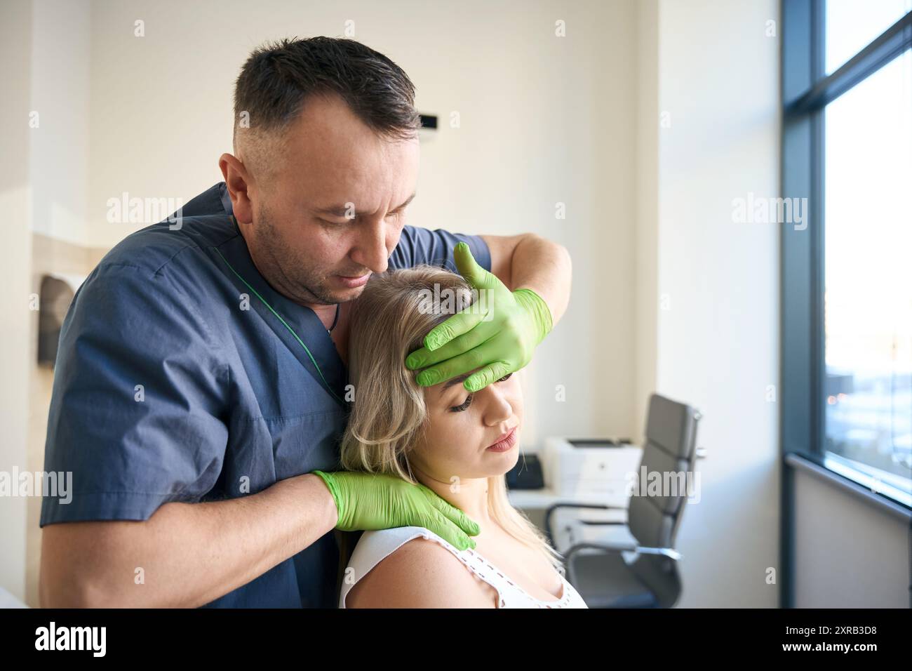 Osteopath carrying out cervical spine manipulation, craniosacral ...
