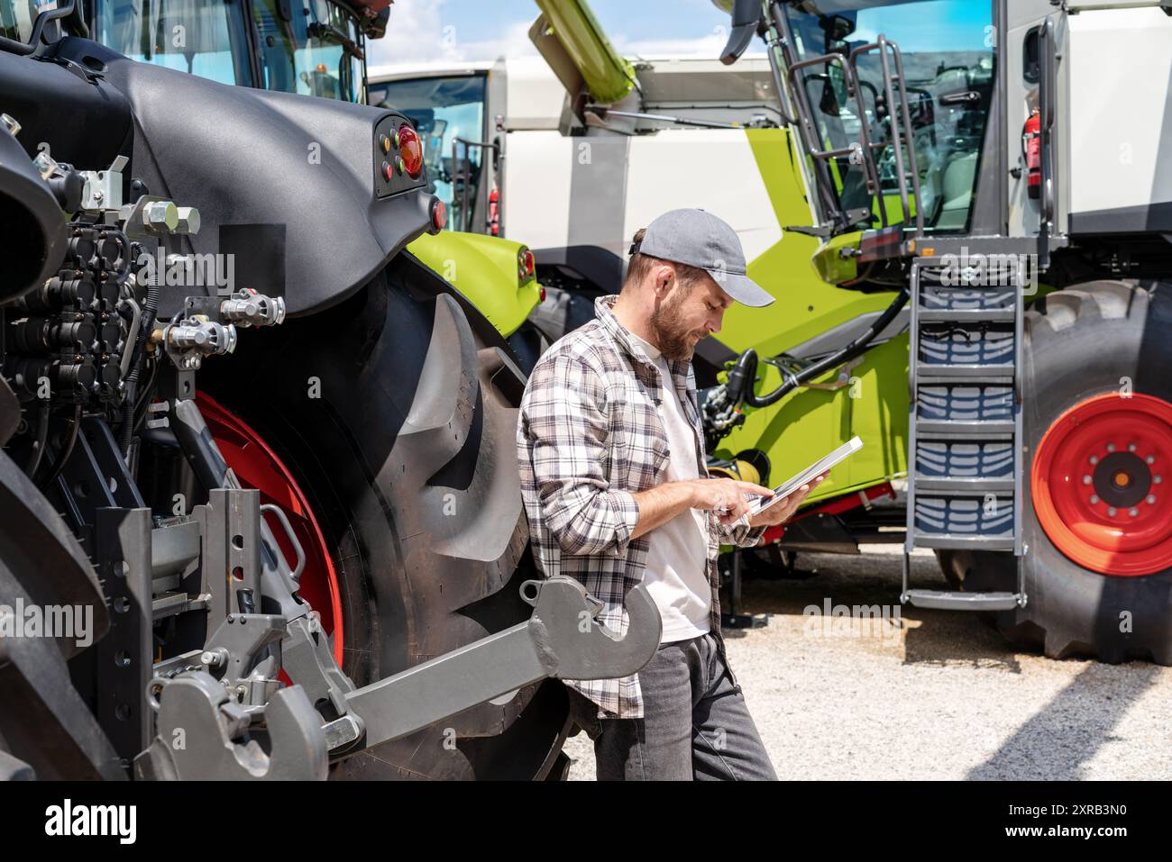 Agricultural equipment dealership. Agribusiness. Man leaned on a ...