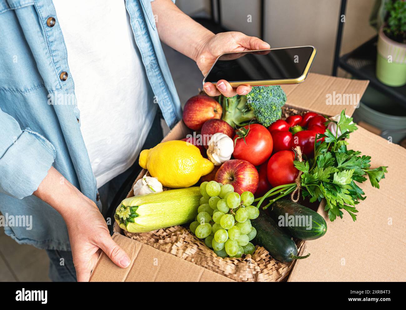 Online ordering farm grown vegetables and fruits. Mobile phone with ...