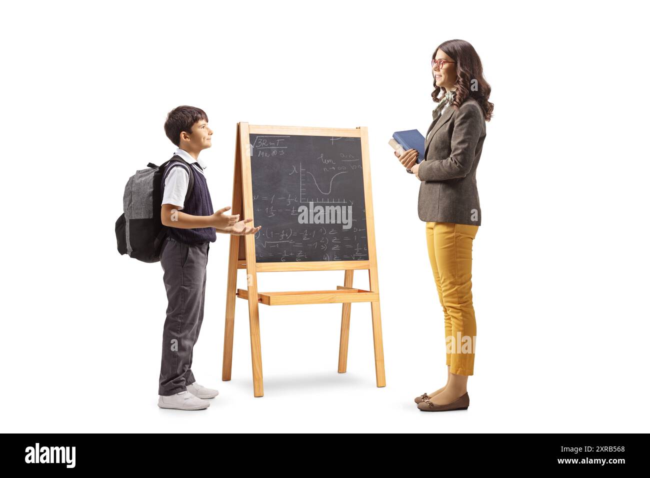 Full length profile shot of a schoolboy talking to a teacher in front ...