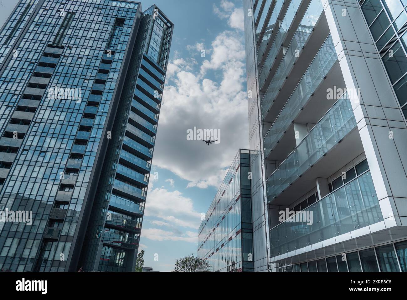 Plane flying over office building. Real estate residenta district ...
