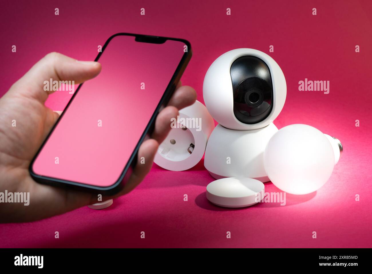 Hand holding smartphone controlling smart home devices Stock Photo - Alamy