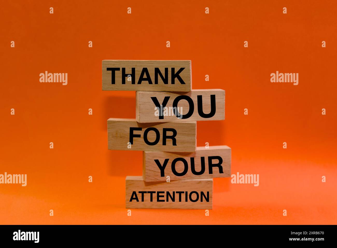 Wooden blocks spell out "Thank You For Your Attention" on a vibrant ...