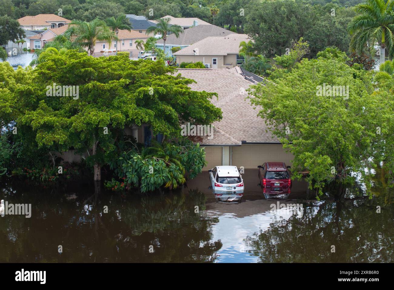 Tropical rainstorm flooded cars residential hi-res stock photography ...