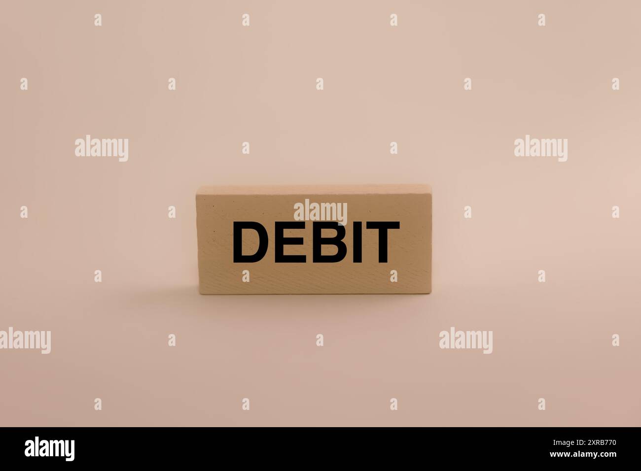 A single wooden block with the word "DEBIT" on a neutral background ...