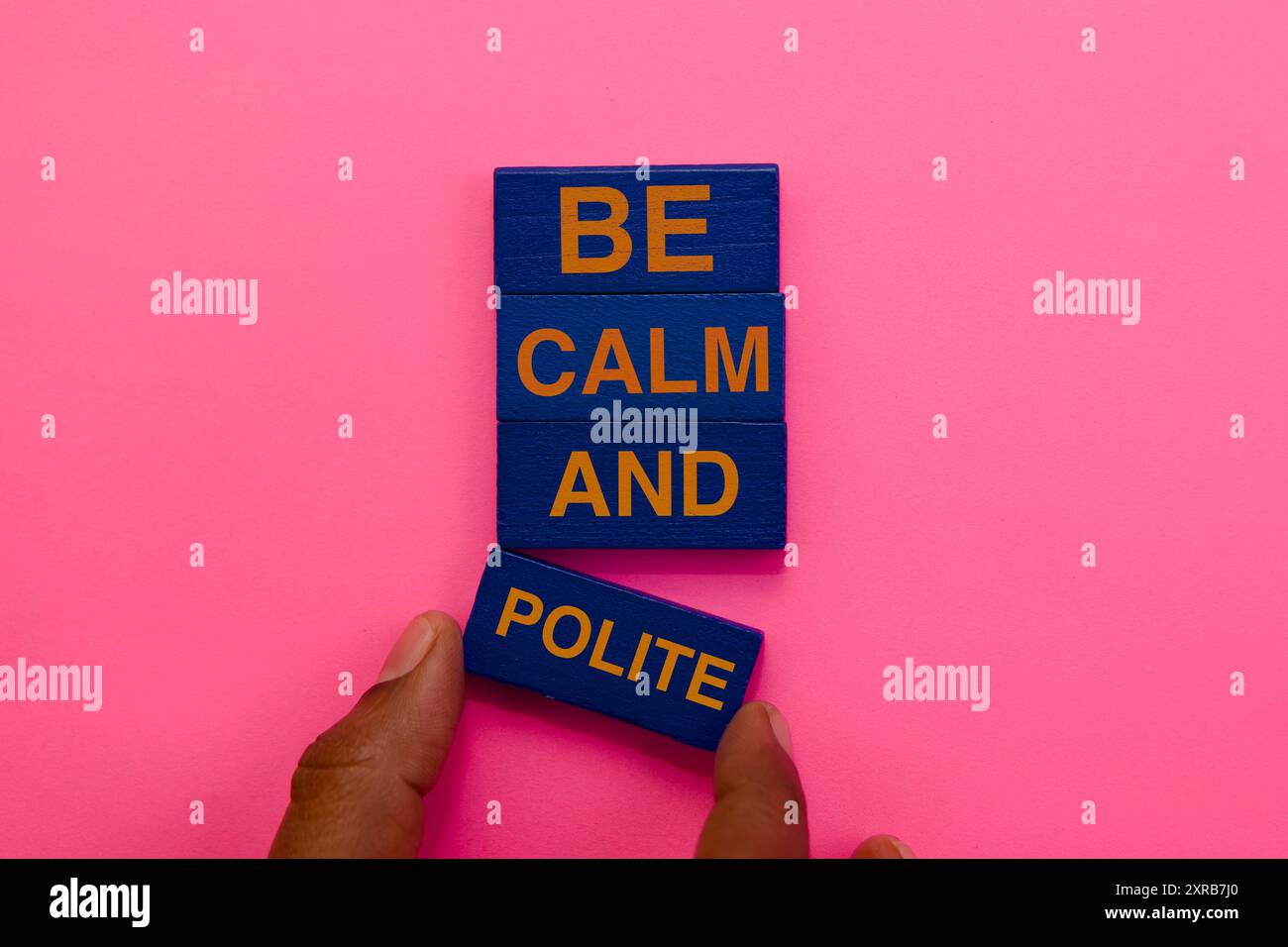 Wooden blocks spelling "Be Calm and Polite," emphasizing the importance ...