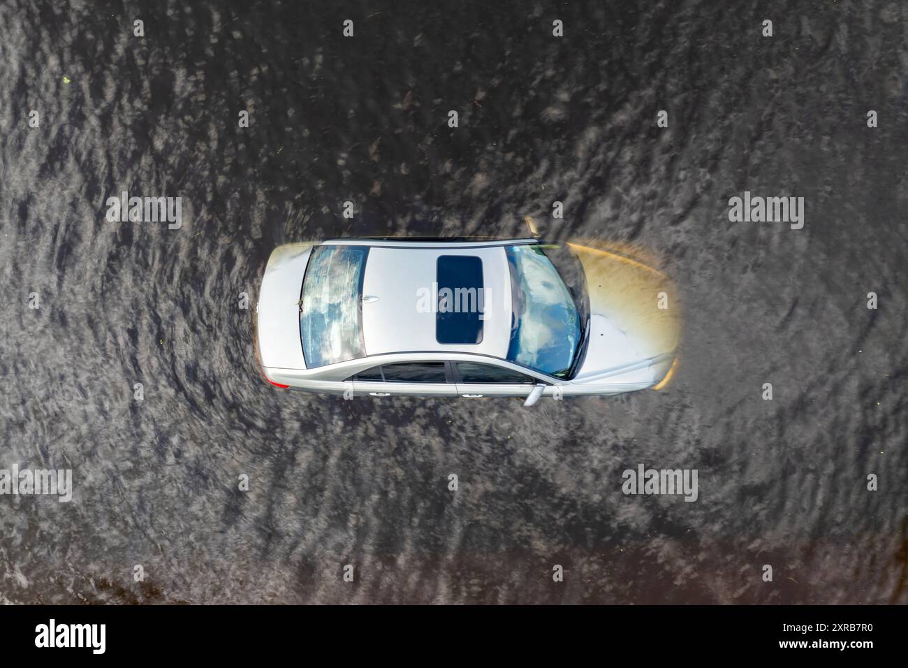 Hurricane flooded car on city street in surrounded with water Florida ...