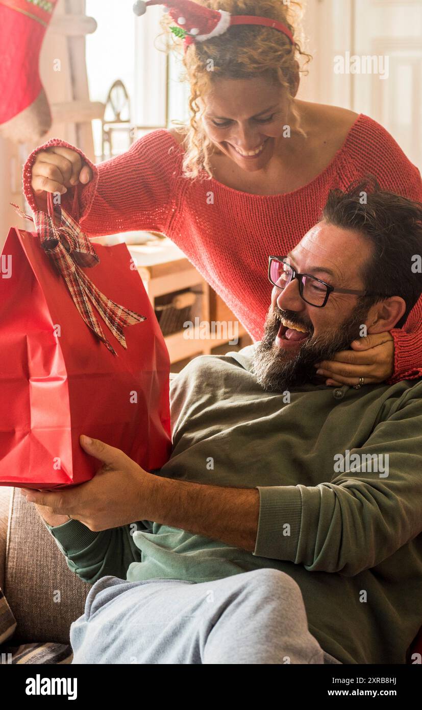 People at home during christmas celebration. Happy woman smile and give ...