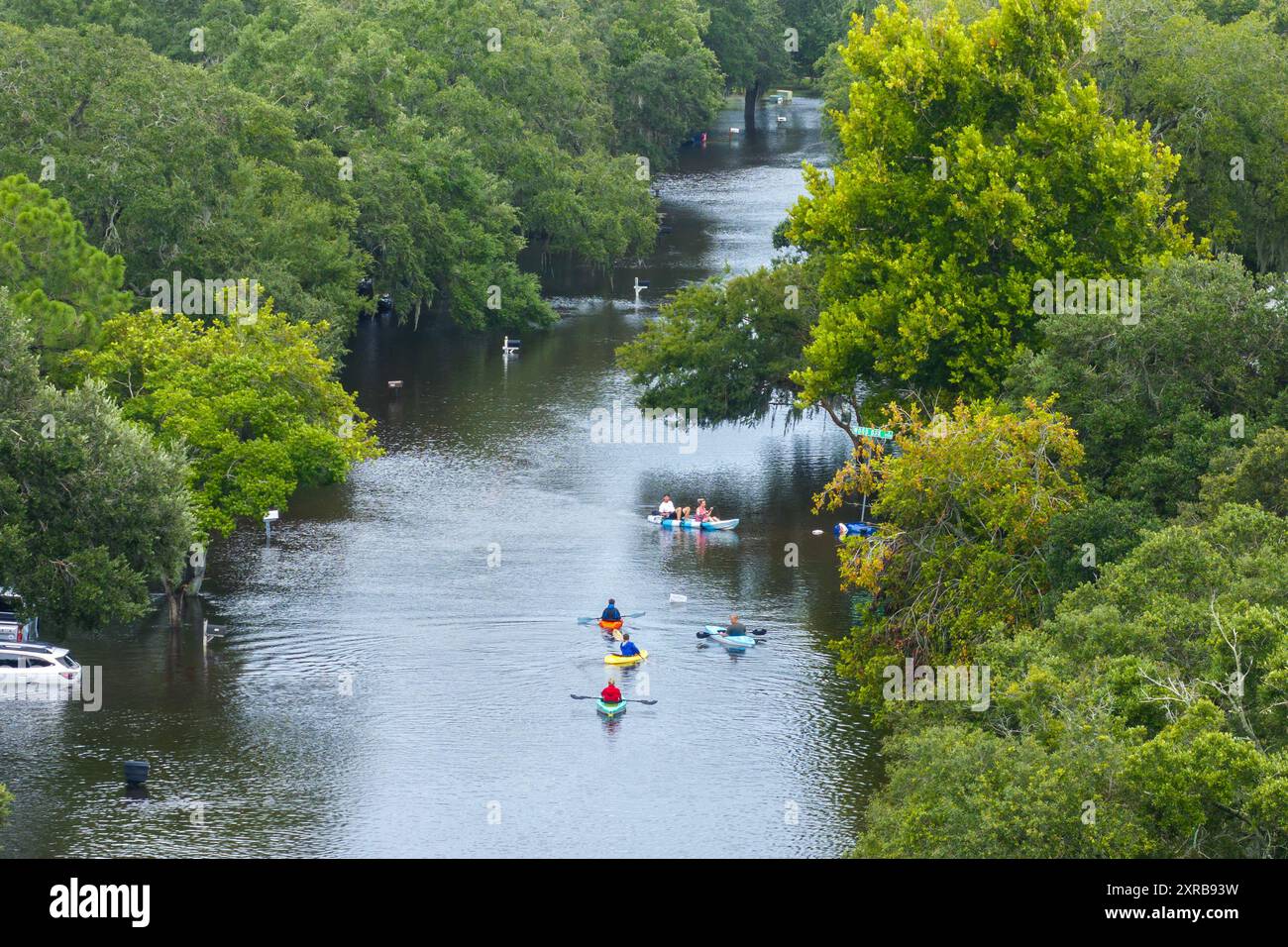Aftermath of hurricane Debby flooding natural disaster. Kayak boats ...