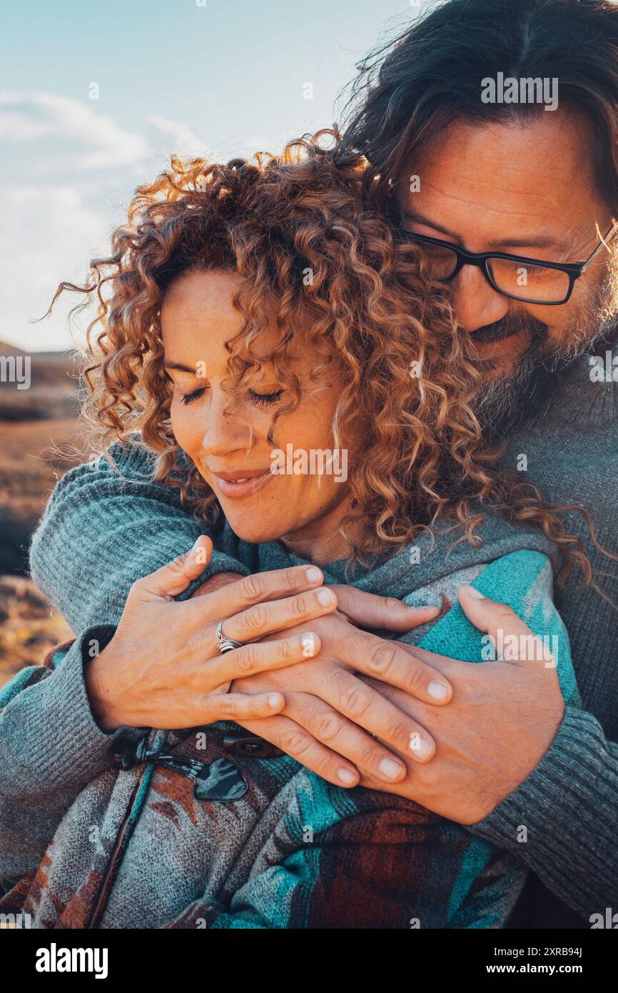 Happy young couple in love hugging outdoors with tenderness and ...