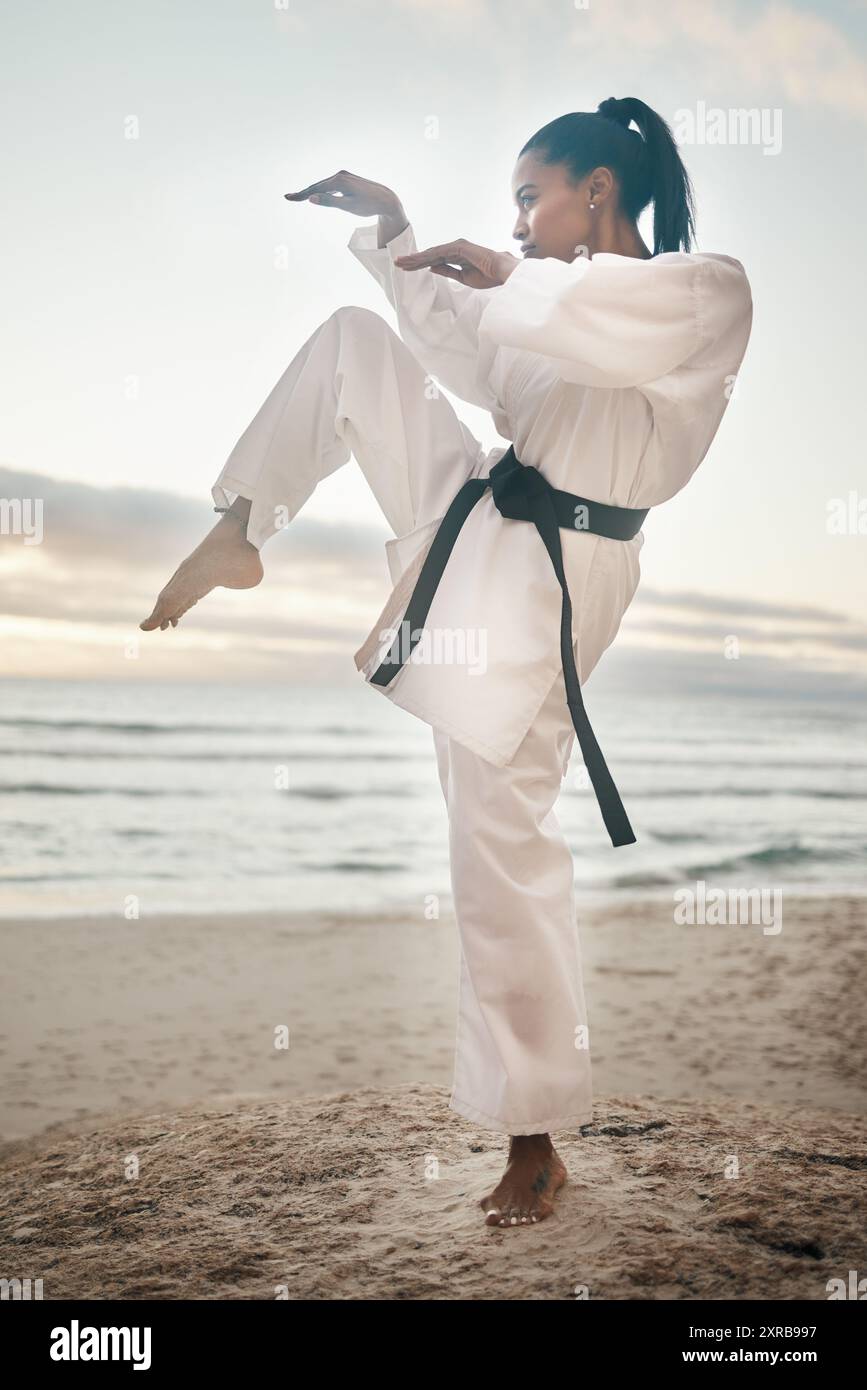 Training, karate and woman at beach for exercise, body health and ...