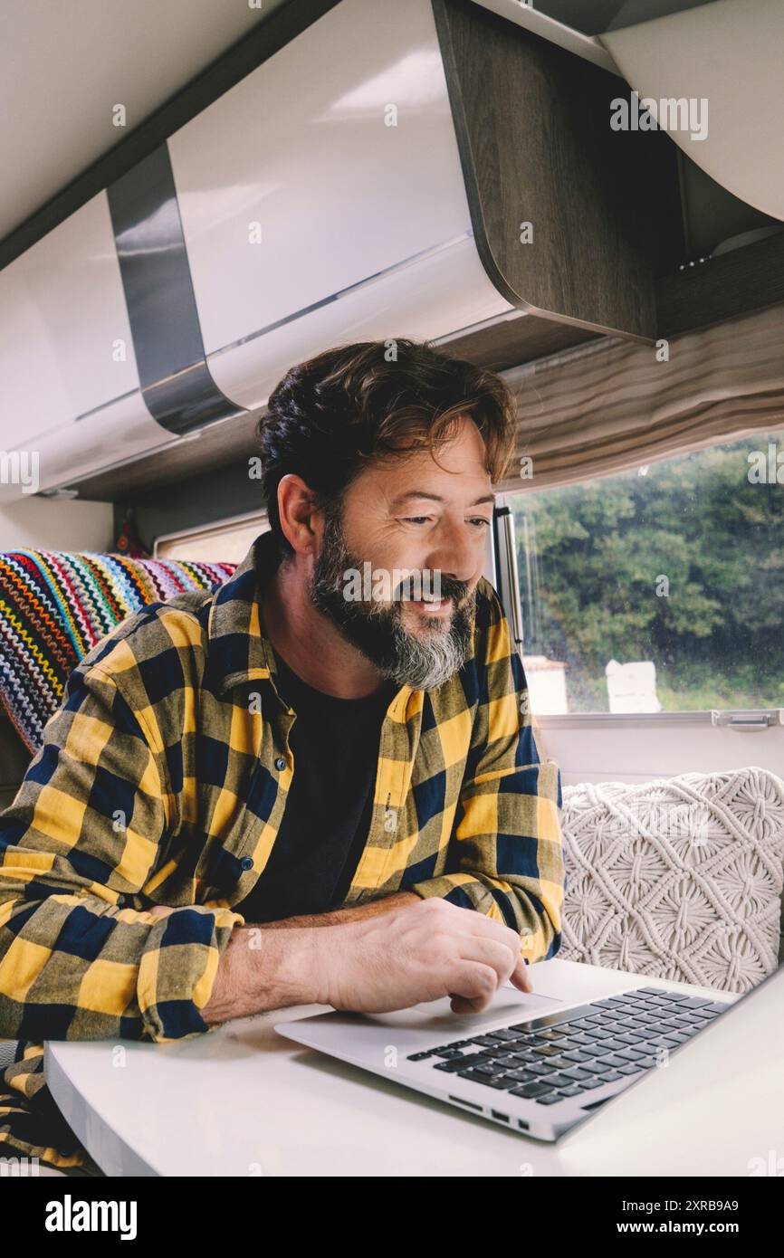 Alternative nomad lifestyle office workstation people. Man working on ...