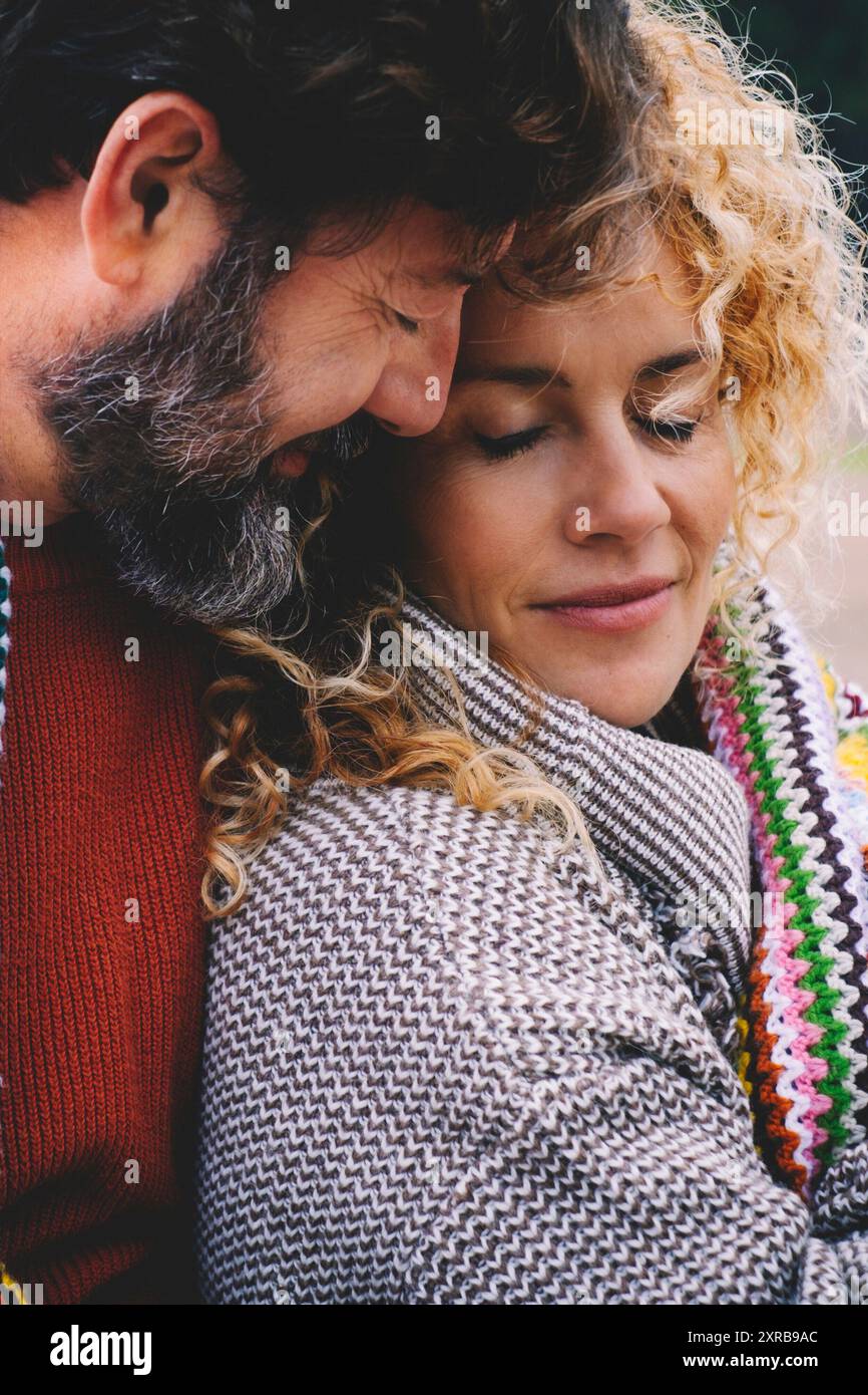 Romantic adult couple stay together with feeling and love covered by a ...