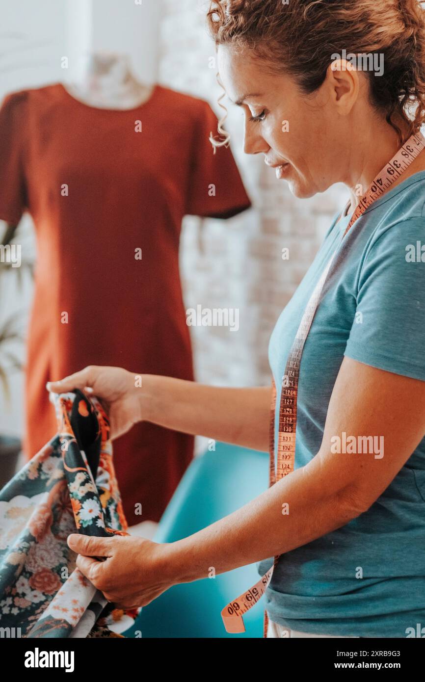 Woman in tailor activity at home or design studio store. Workshop of ...