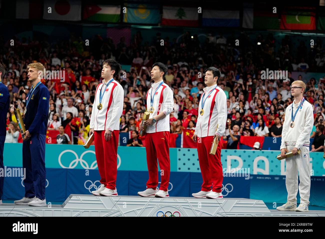 The gold medalists, players of China sing the national anthem, during ...