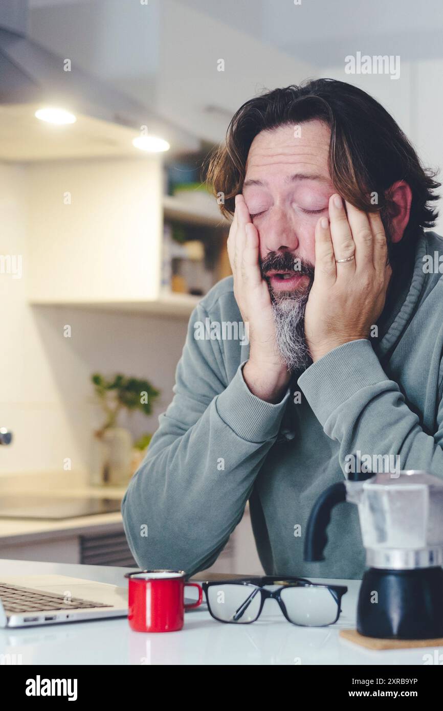 Tired man at home in morning wake up activity touching face and ...