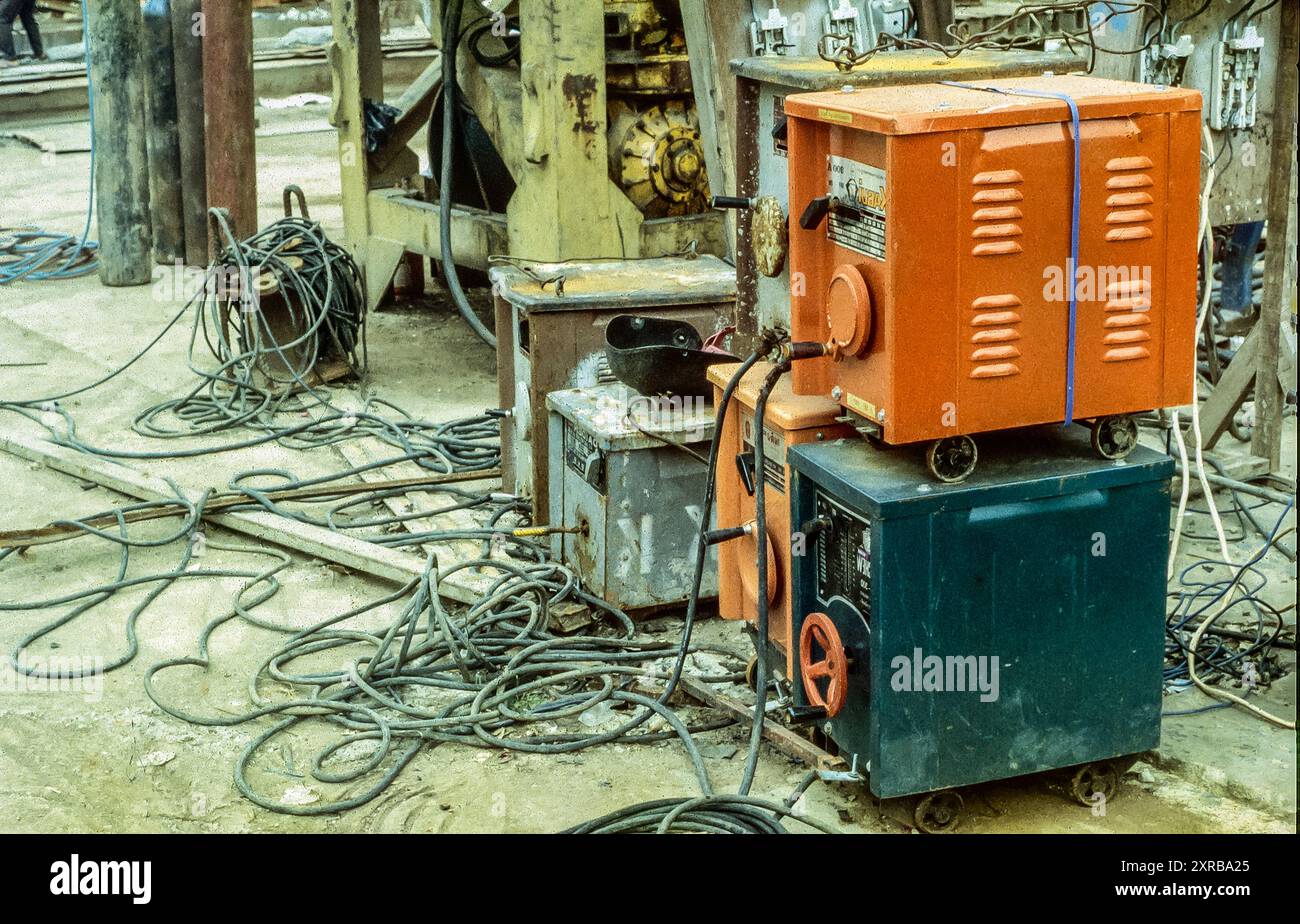 The image is of electric arc welding machines on a construction site ...