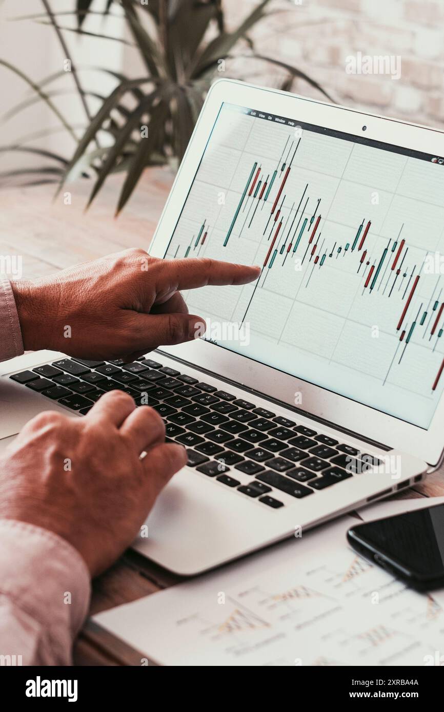Back view of man reading forex chart on laptop display. Bad indication ...