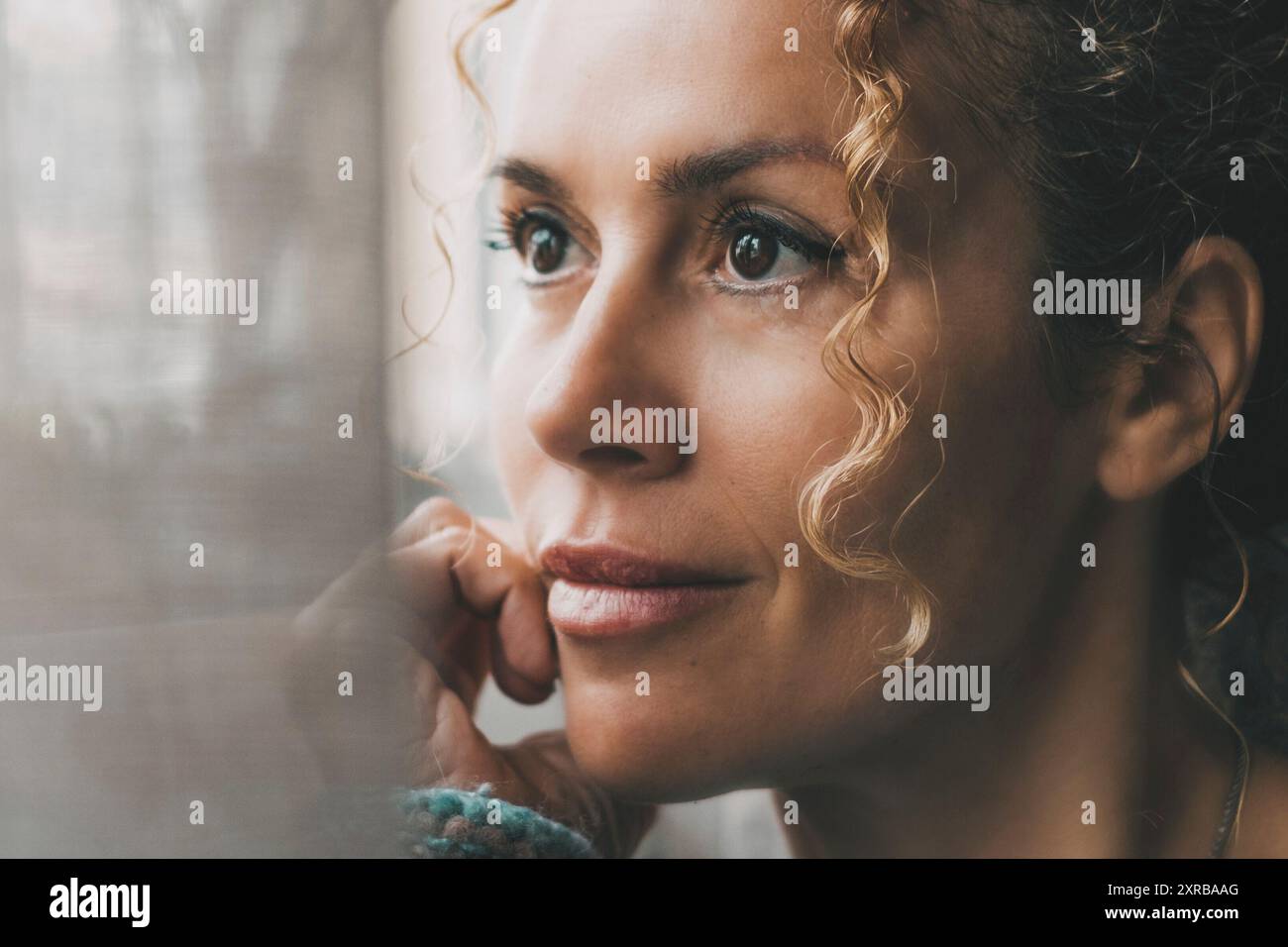 One confident lady contemplate outside the window at home with dreaming ...