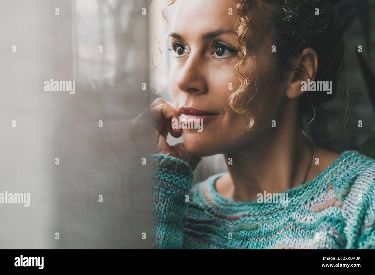 One confident lady contemplate outside the window at home with dreaming ...