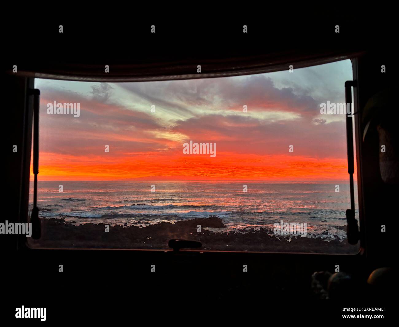 Colorful sunrise viewed from inside a camper van motorhome. Concept of ...