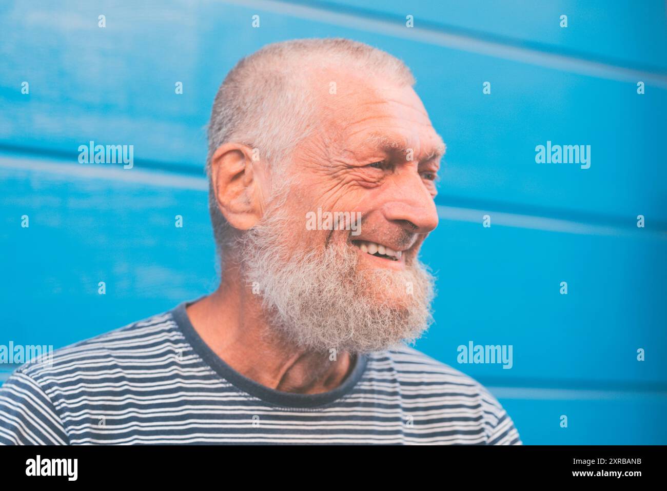 75 year old senior man laughs while having a good time outdoors ...