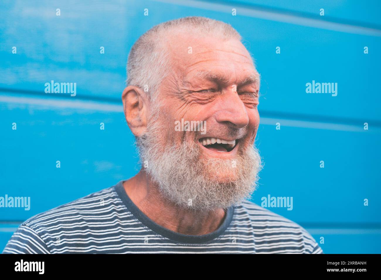 75 year old senior man laughs while having a good time outdoors ...