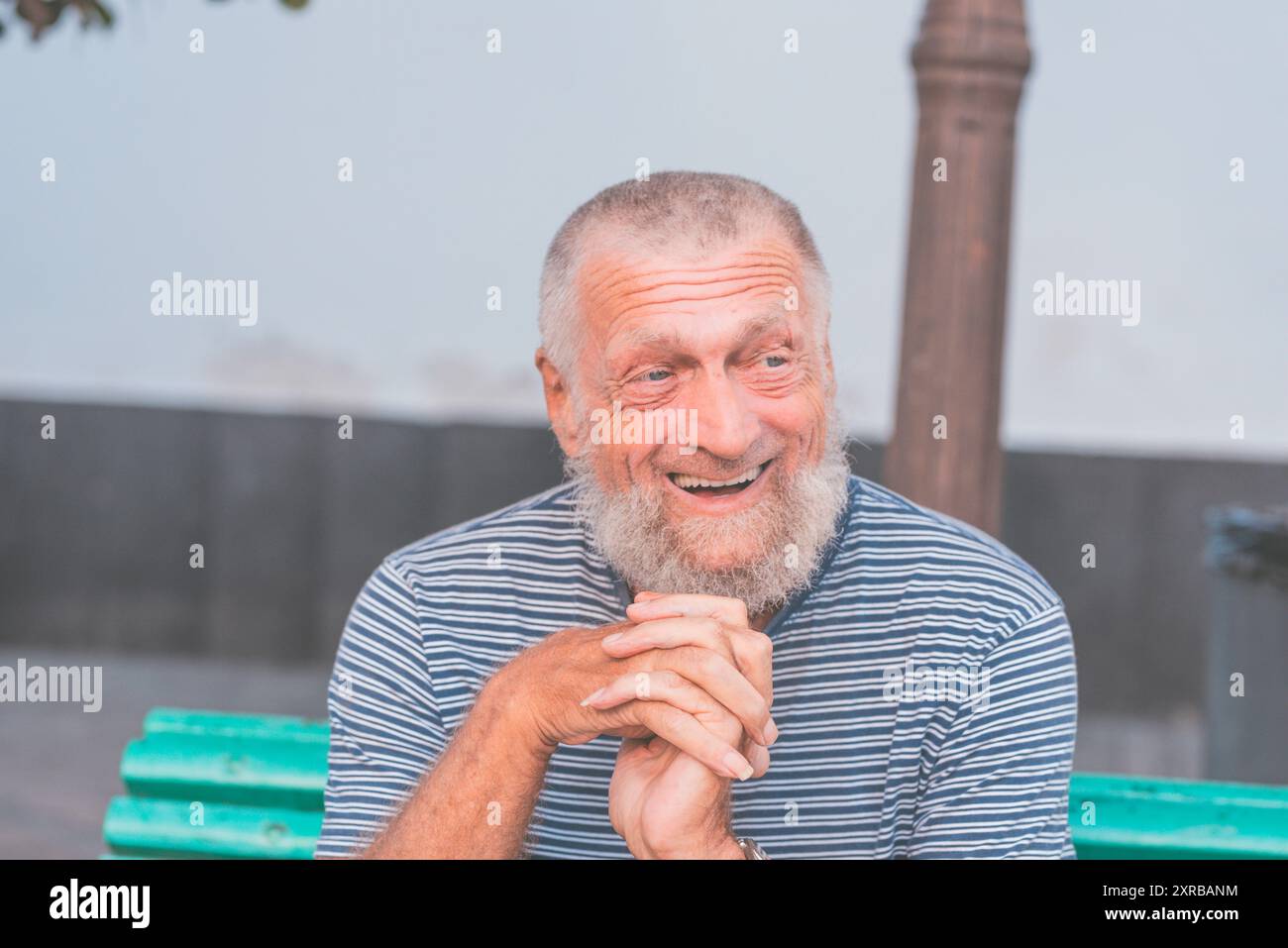 75 year old senior man laughs while having a good time outdoors Stock ...