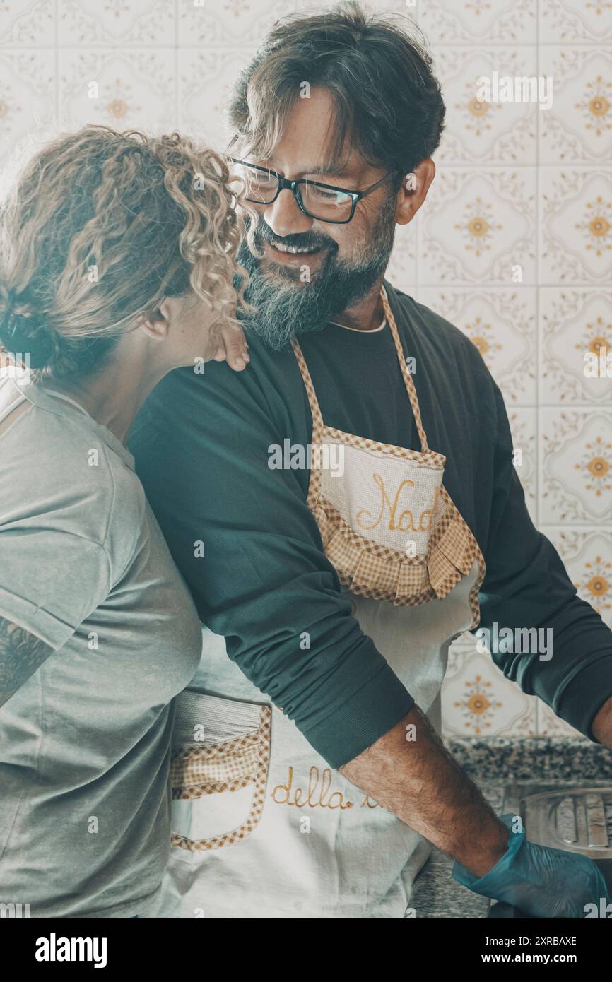 Happy couple adult people in love washing dishes together in the ...