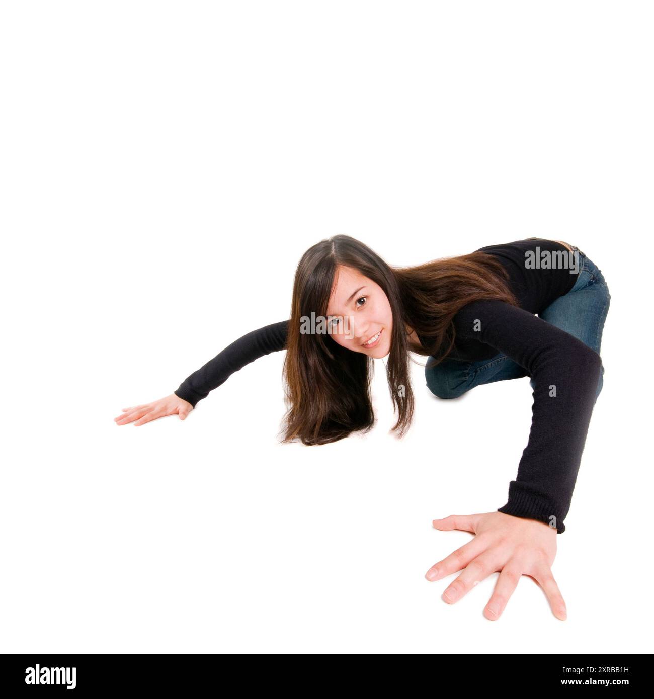 Ground level extreme wide angle view of a young Thai woman kneeling on ...