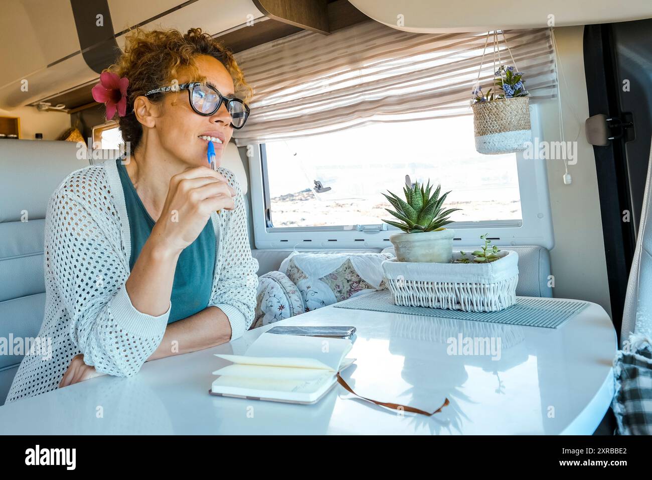 One adult woman reading and writing notes inside a camper van. Modern ...