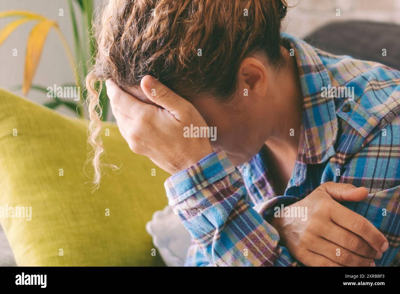 Sad tired young woman touching forehead having headache migraine or ...