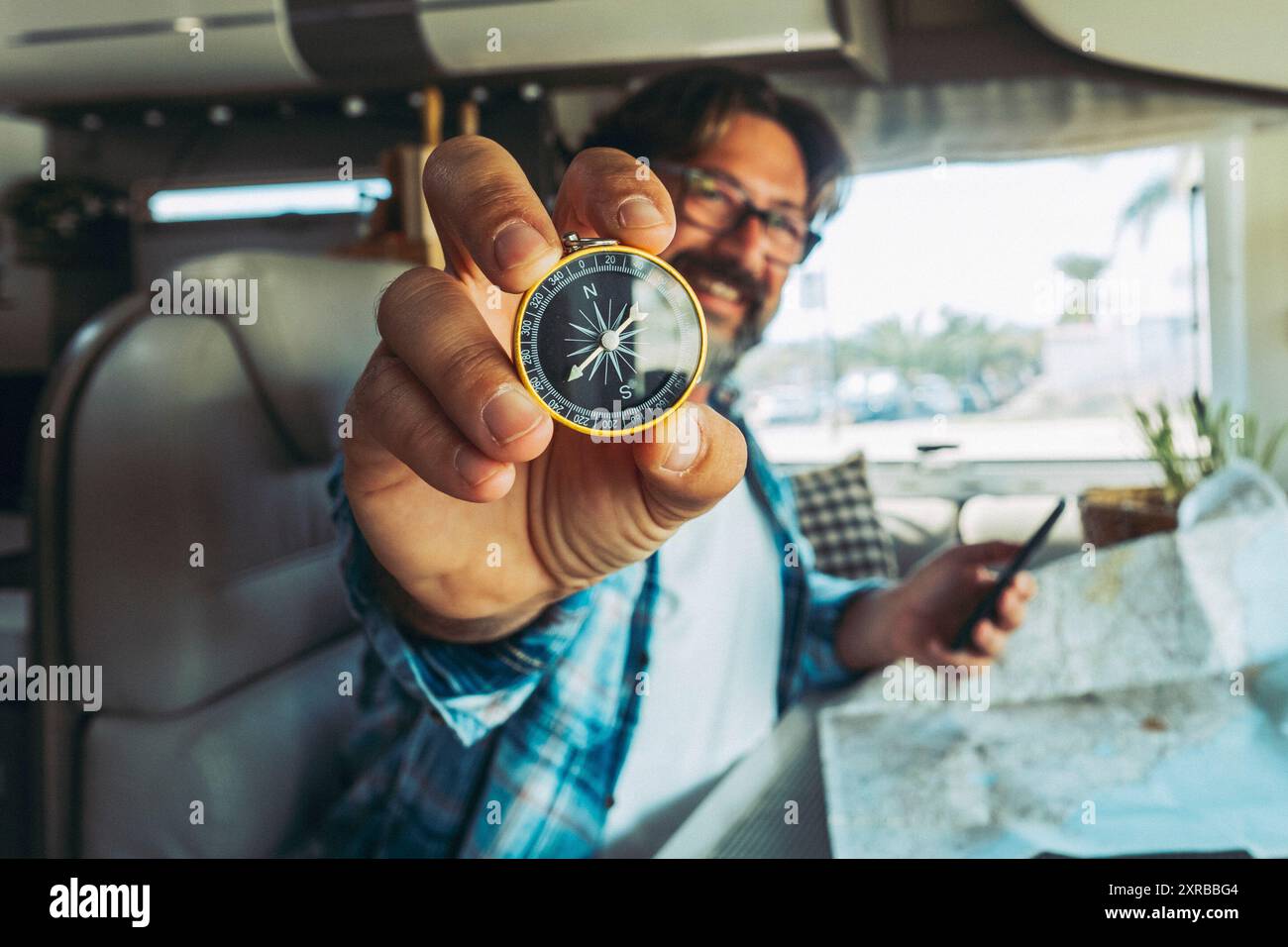 Travel and adventure lifestyle concept. One man showing compass at the ...
