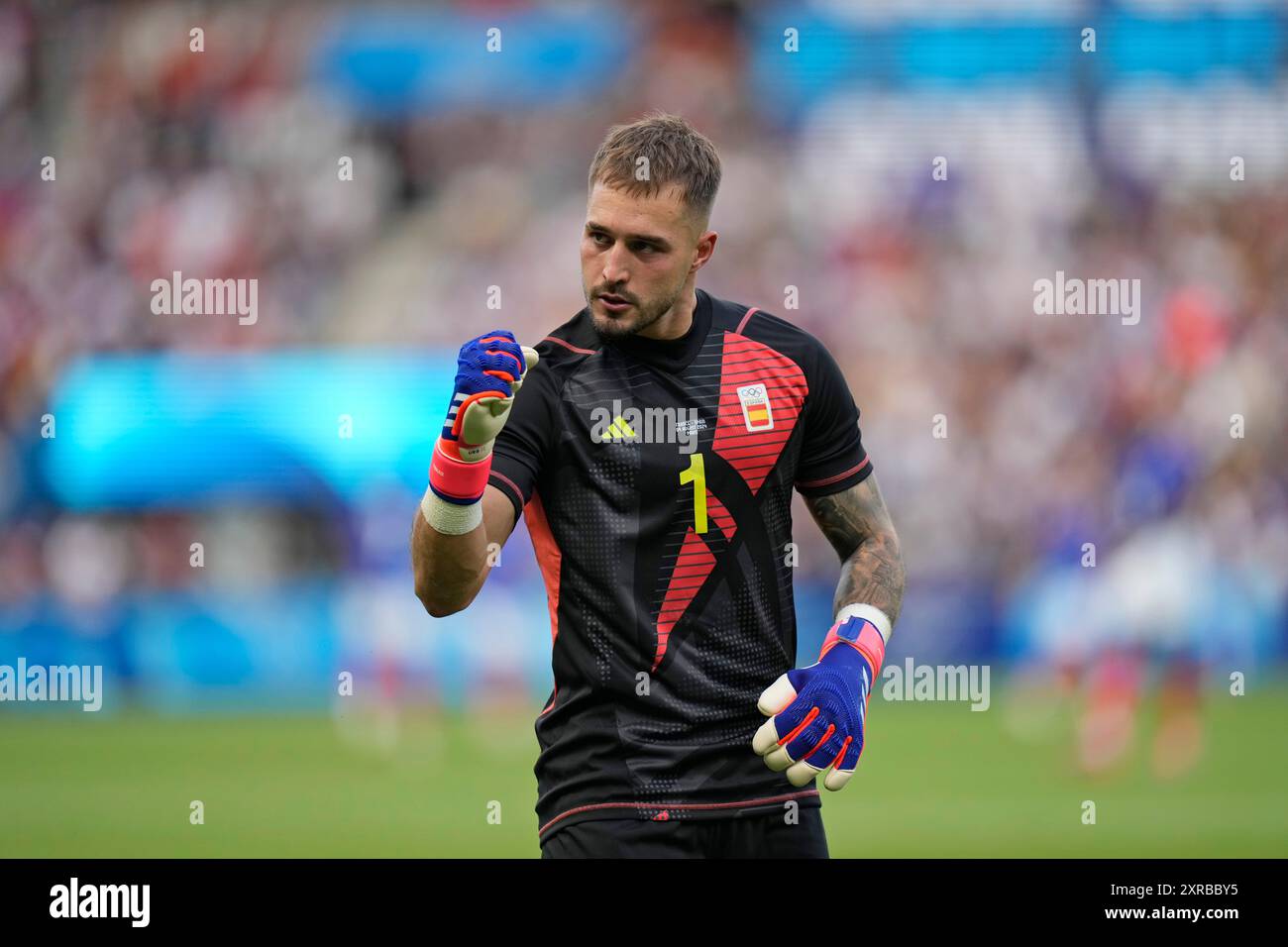 Spain's goalkeeper Arnau Tenas celebrates his team's first goal during ...